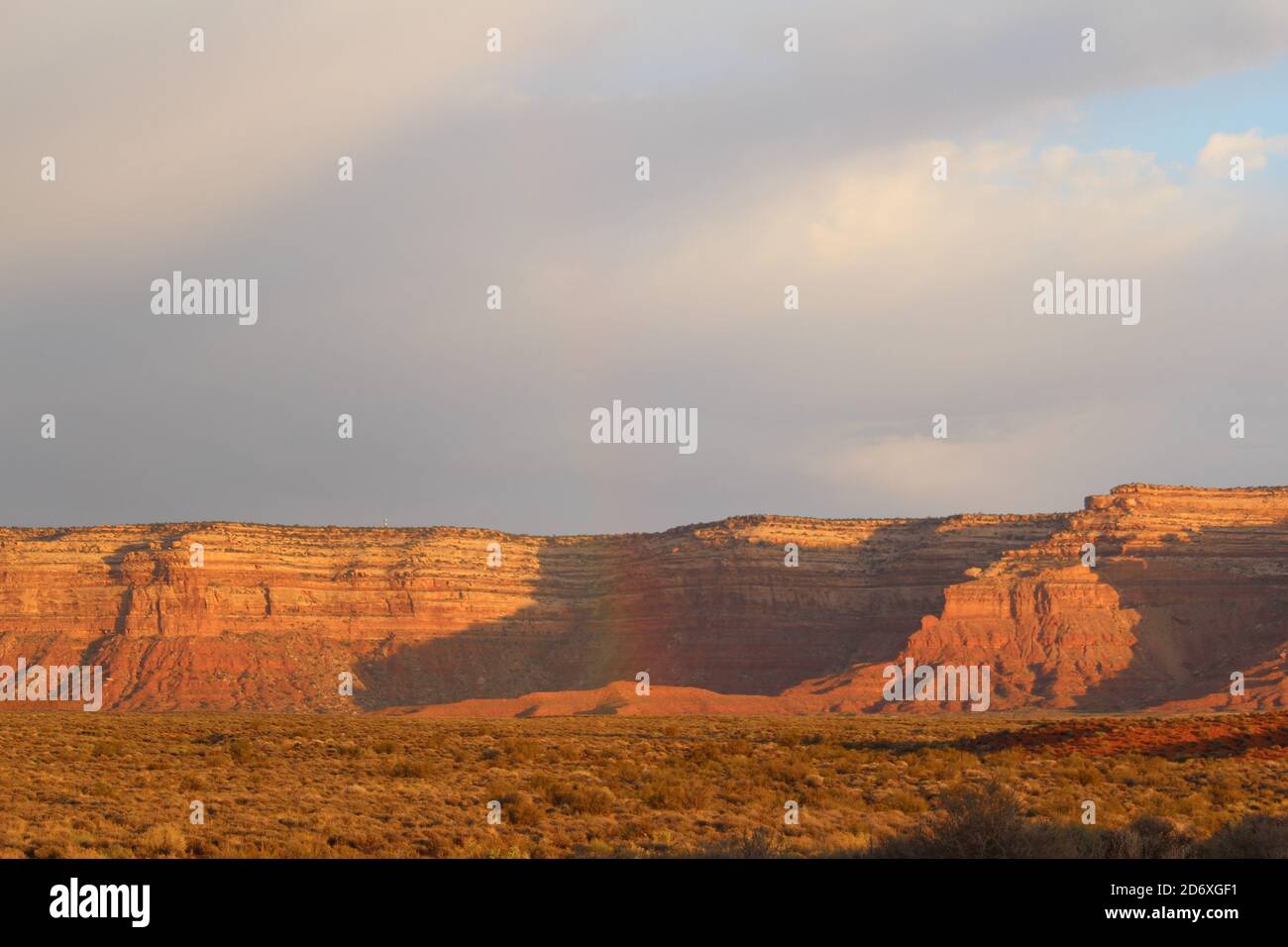 Nice rainbow coming over a large sandstone cliff in Valley of the Gods ...
