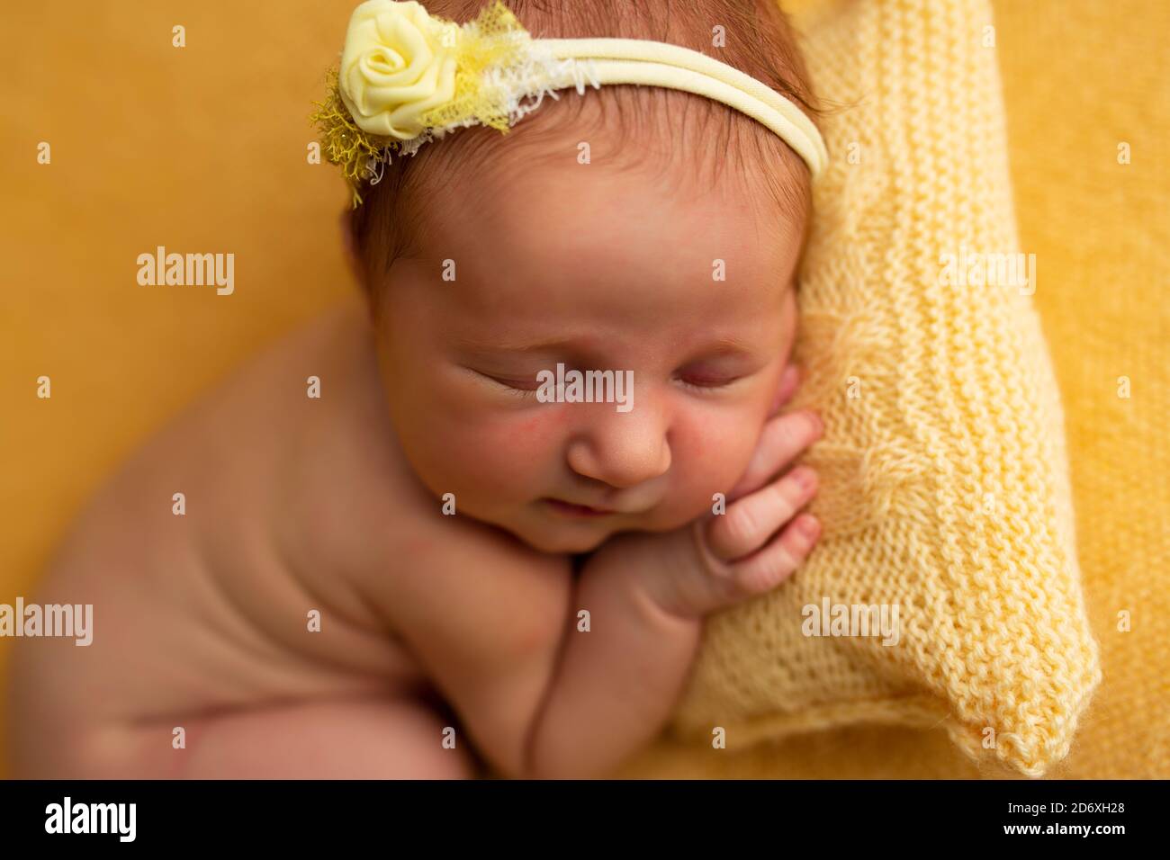 Cute baby newborn napping on pillow on a yellow blanket Stock Photo - Alamy