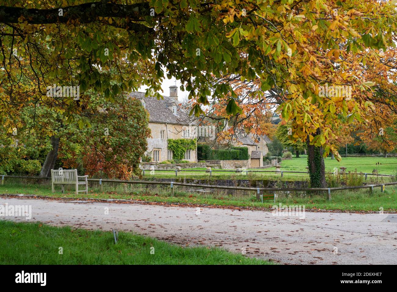 Autumn trees and a Cotswold stone house in Wyck Rissington, Cotswolds ...