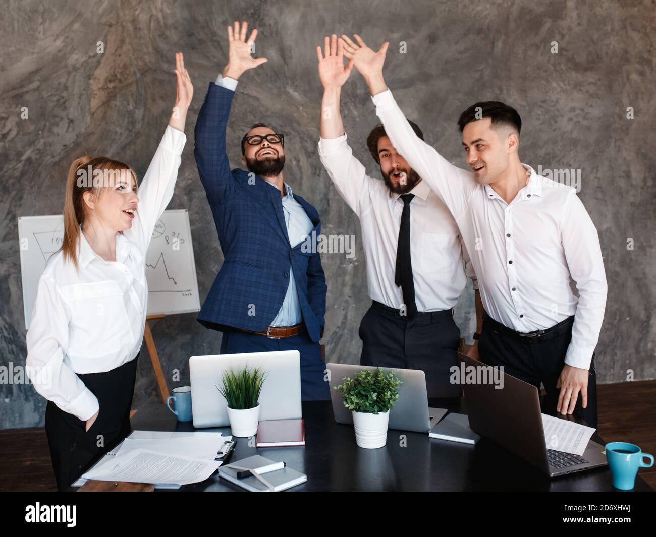 Excited multiracial office associates employees group giving high five ...