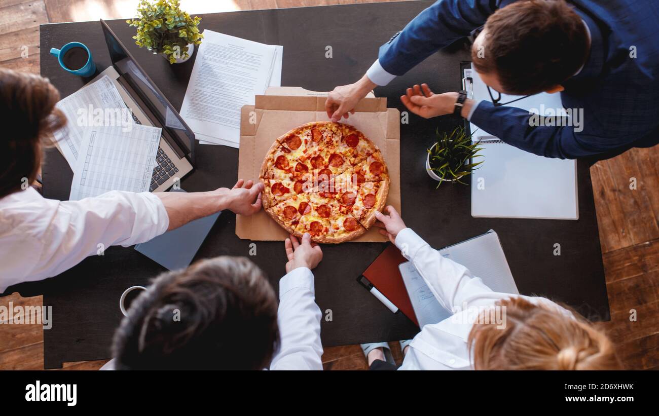 Happy Diverse Colleagues Spend Work Break Together Eating Takeaway