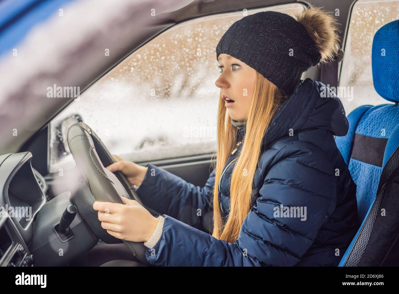 Woman in a car during a snowfall, problems on the road Stock Photo - Alamy
