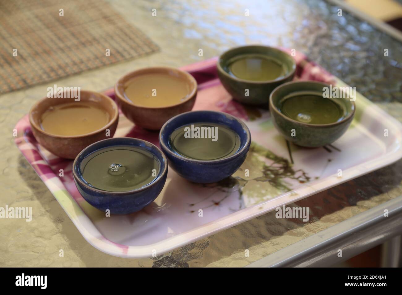 Close up shot of traditional Chinese tea cup set filled with tea on a ...