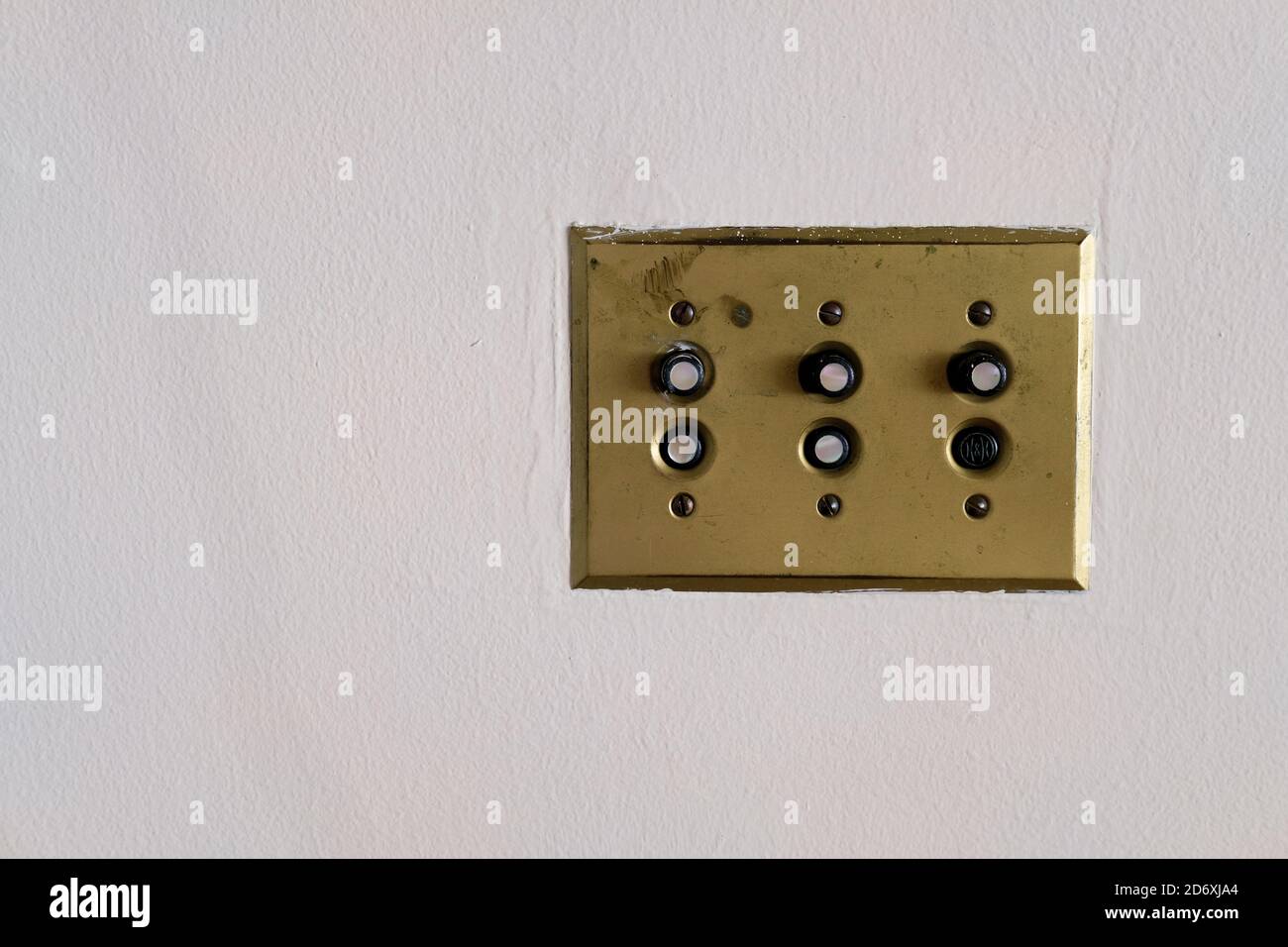 H&H Arrow single pole push light switches mounted on a brass plate on a ...