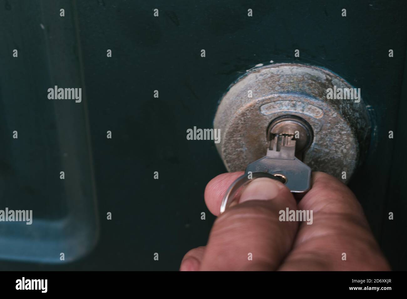 Selective focus shot of a male putting keys in a house lock Stock Photo ...