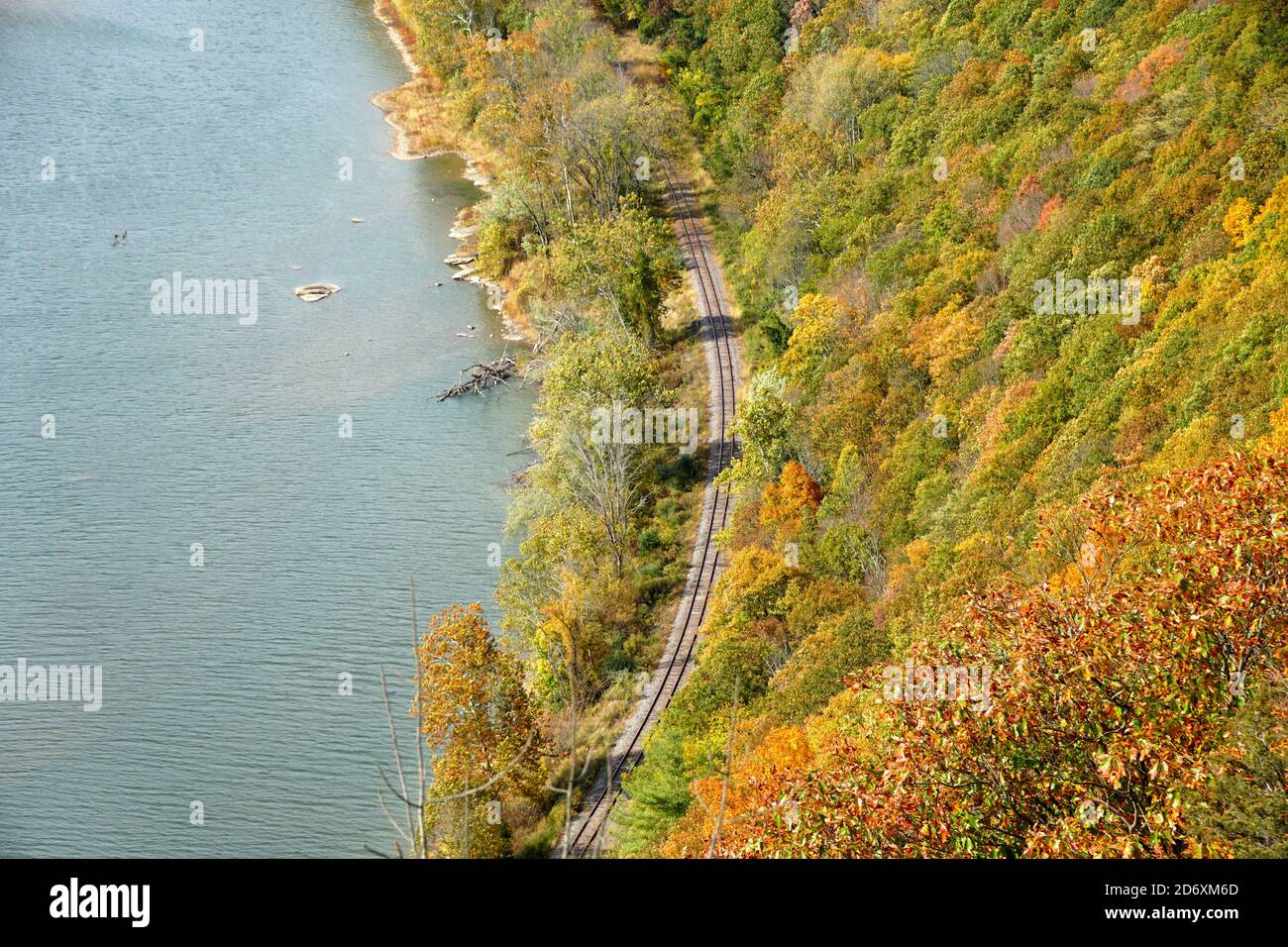 The aerial view of the train track surrounded by striking color of fall ...