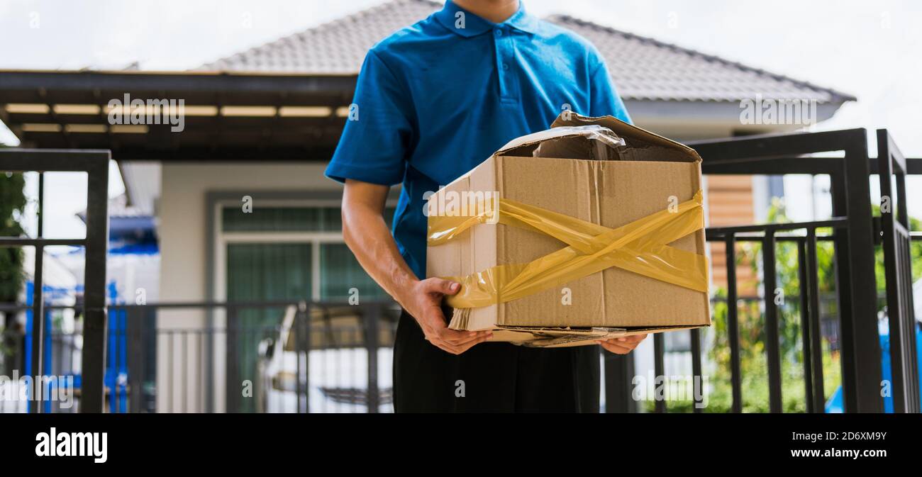 Asian young delivery man in blue uniform he emotional falling courier ...