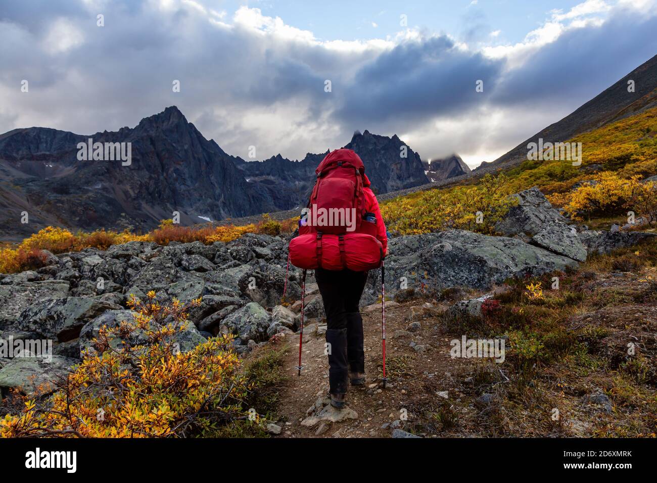 Woman Backpacking on Scenic Hiking Trail surrounded by Rugged Mountains ...