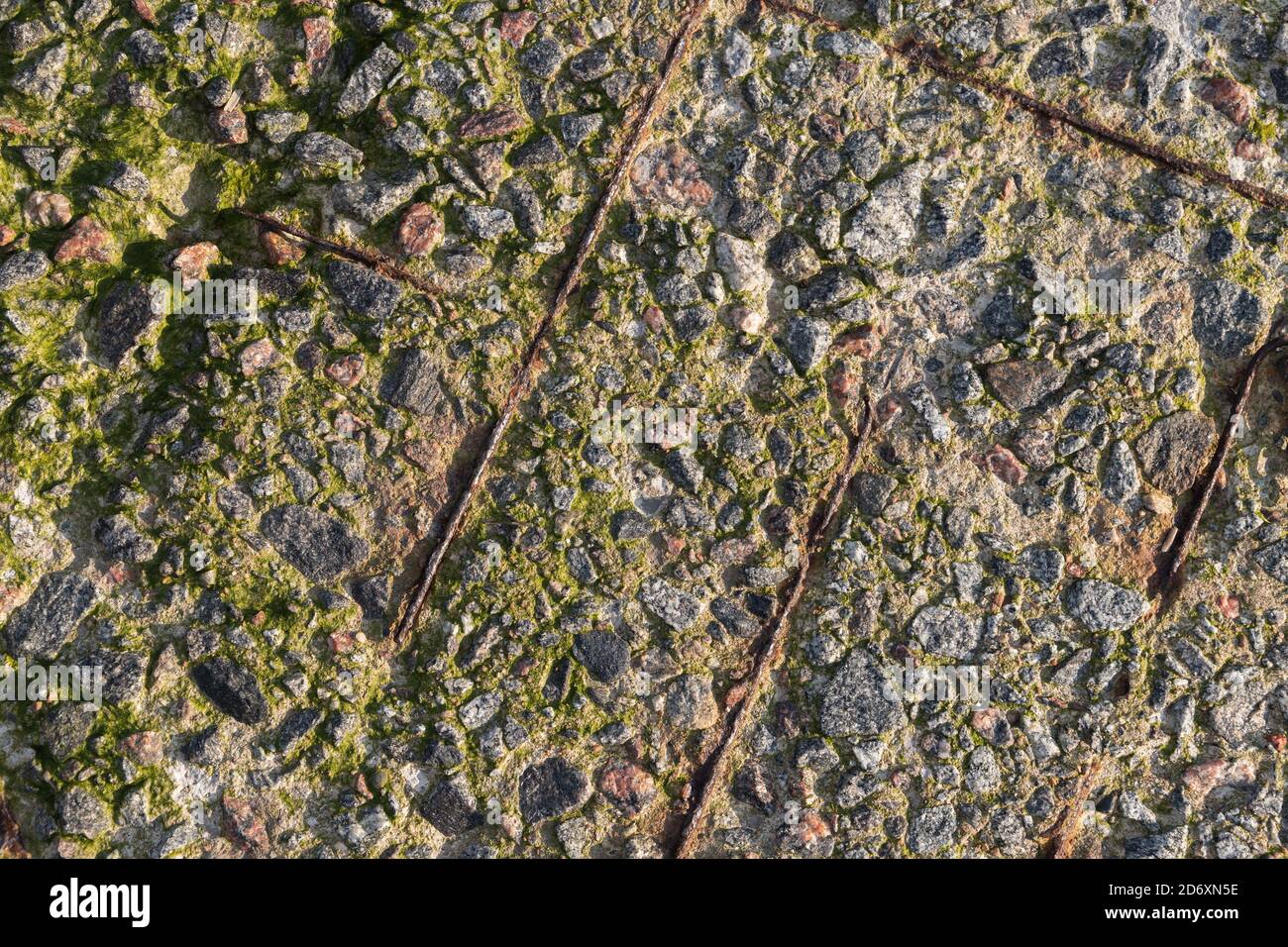 Grungy concrete pier with rusty steel carcass, background photo texture ...