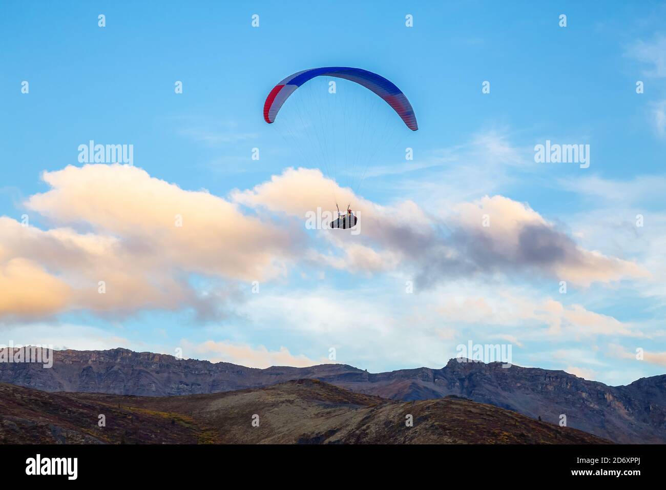 Paraglider flying over Scenic Mountain Range in Canadian Nature Stock ...
