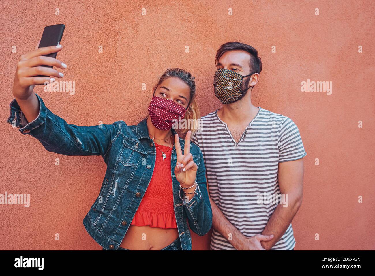Friends taking a selfie with face mask on in coronavirus time for ...