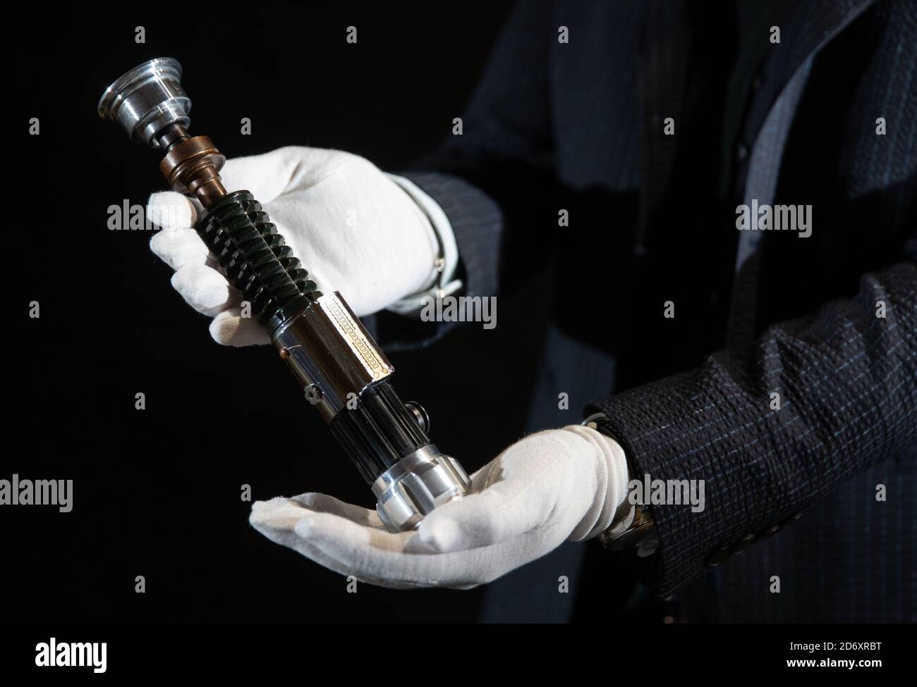 Prop Store CEO Stephen Lane holds Obi-Wan Kenobi's (Ewan McGregor ...