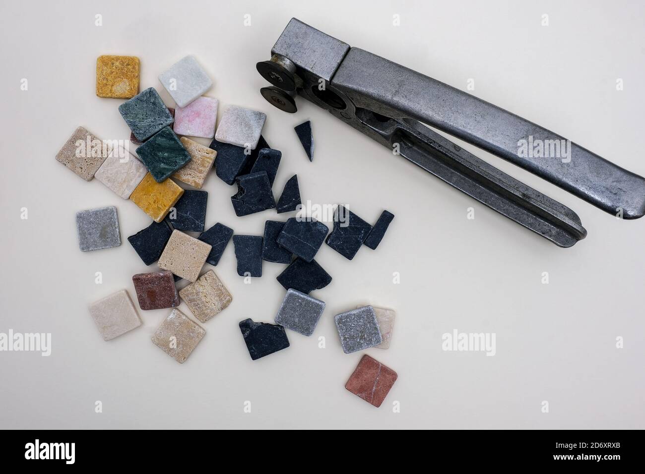 colorful small marble stones in a square shape with special pliers for ...