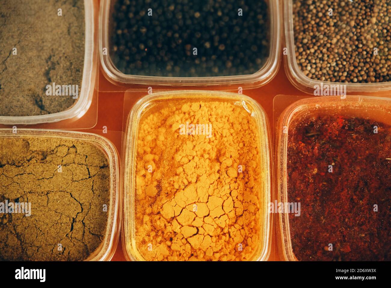 various colorful spices and herbs packed in small transparent plastic ...