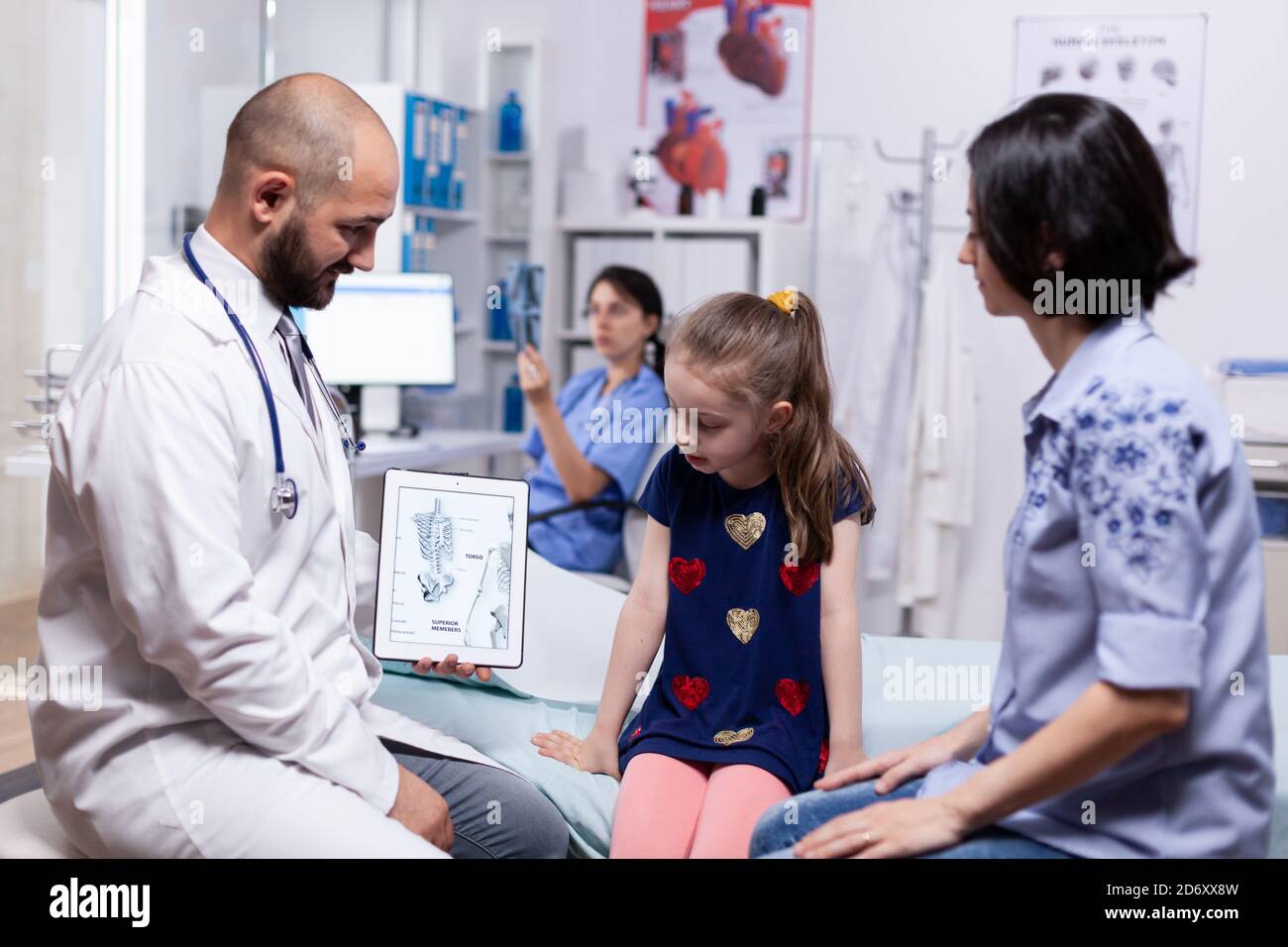 Doctor talking about diagnosis with mother of sick child in hospital ...