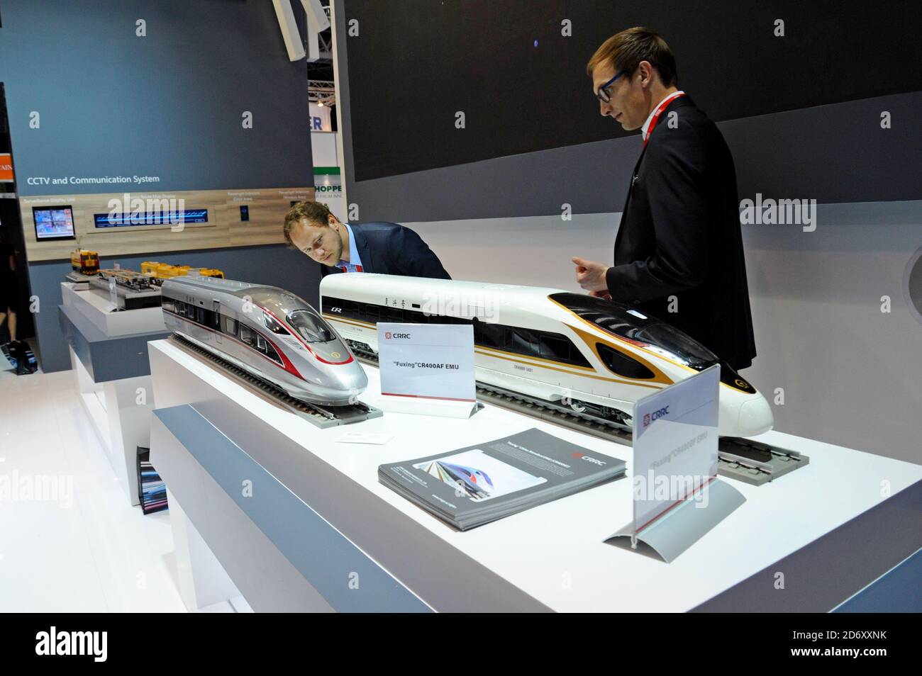 Visitors examining models of high speed trains on the CRRC China ...