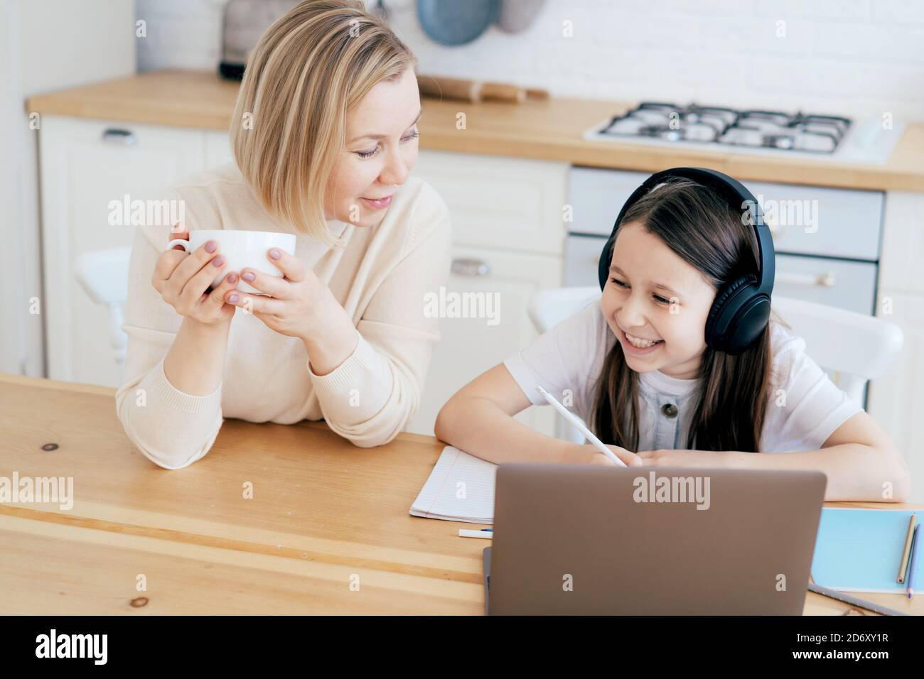 mom and daughter do homework on the computer Stock Photo - Alamy