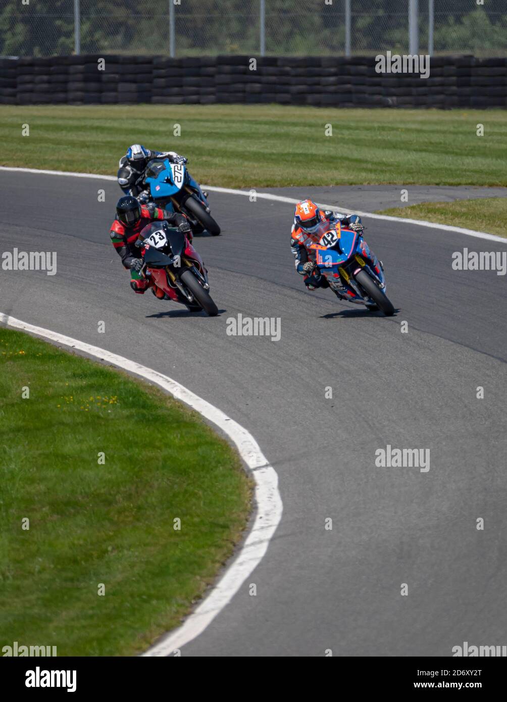 A shot of several racing bikes cornering on a track Stock Photo - Alamy