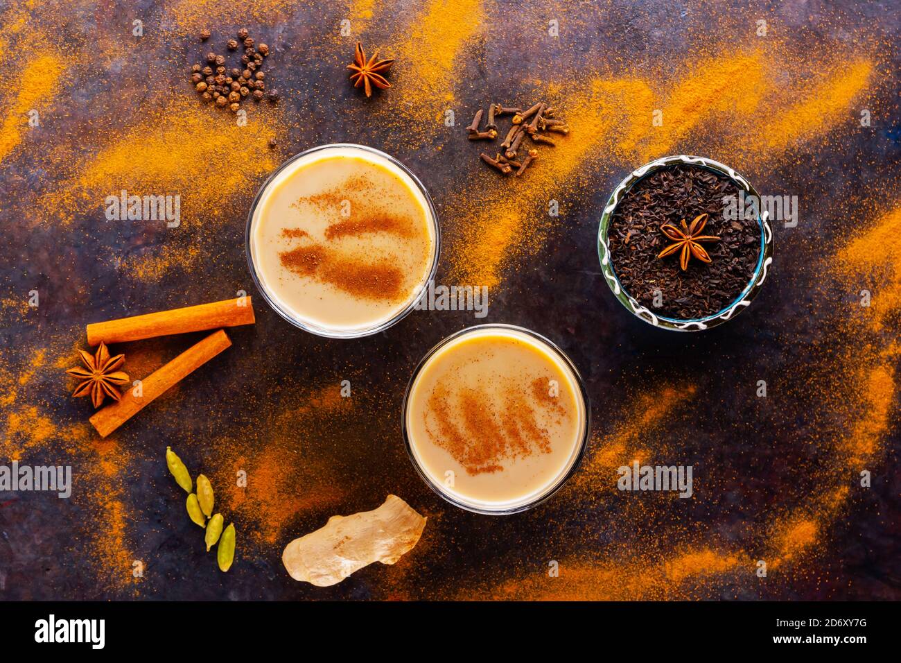 Masala chai tea on a black background. Two transparent glasses of ...