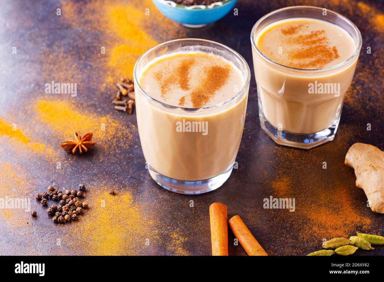 Masala chai tea on a black background. Two transparent glasses of ...