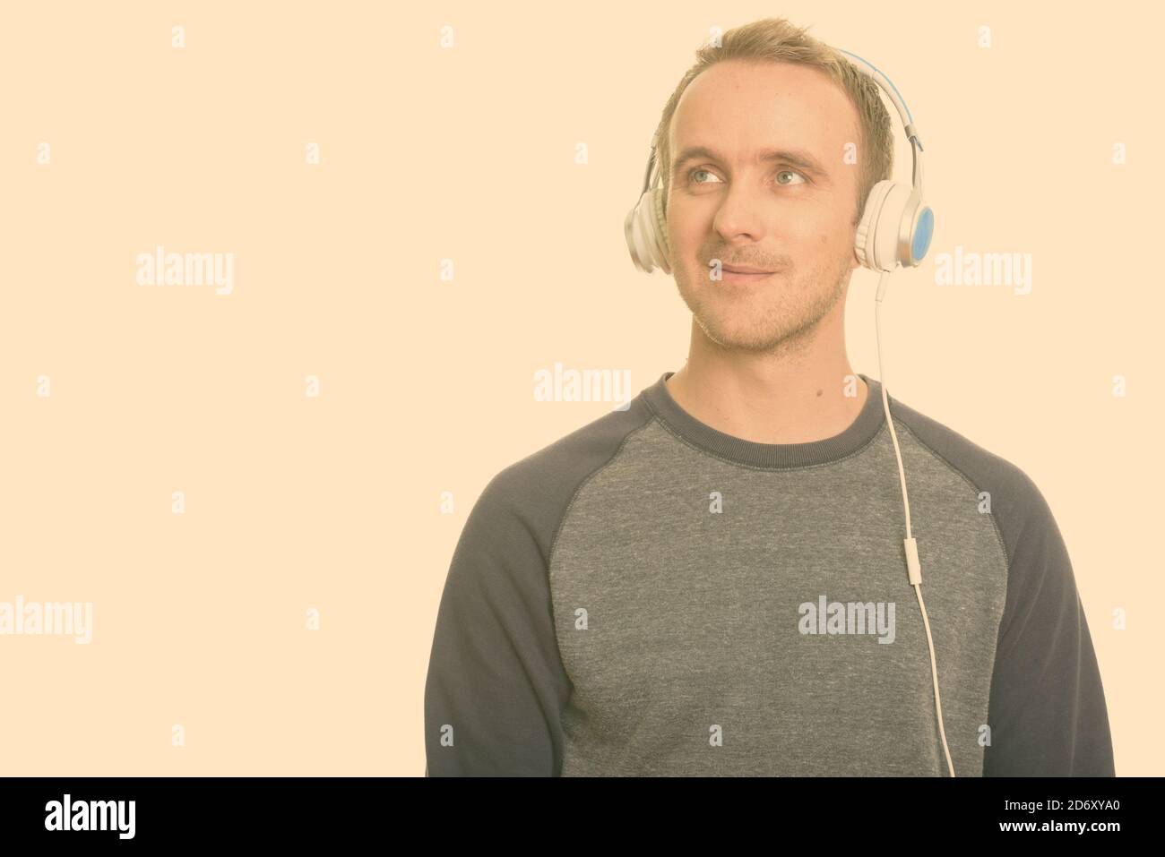 Handsome Caucasian man listening to music while thinking Stock Photo ...