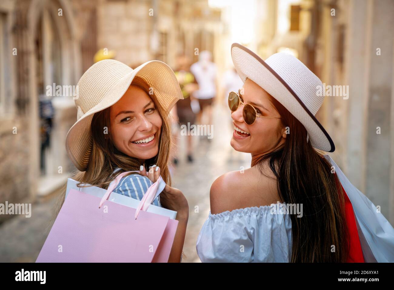 Sale, consumerism, shopping and people concept. Happy young women with ...