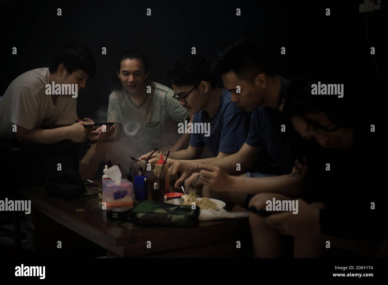 A group of vapers having leisure time with meals and e-cigarette ...