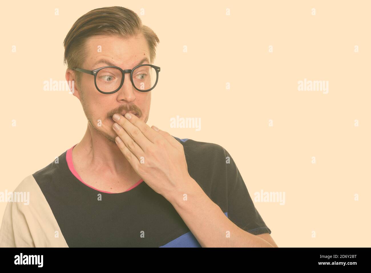 Portrait of young handsome bearded man as nerd looking shocked Stock ...