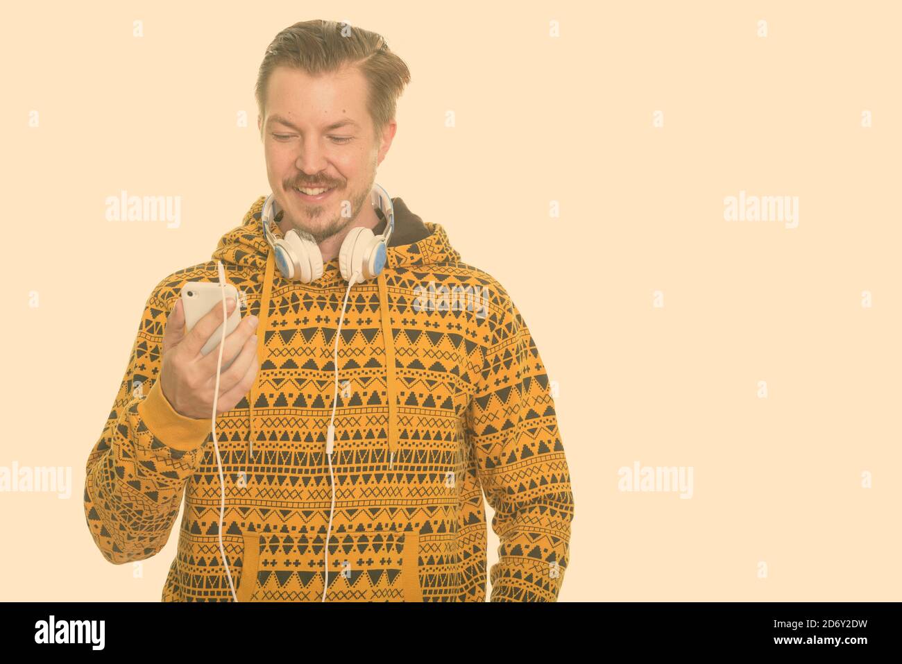 Using smartphone with headphones around neck hi-res stock photography ...