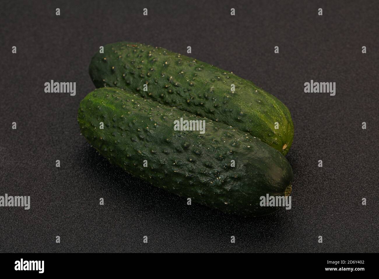 Green fresh two cucumbers over background Stock Photo - Alamy