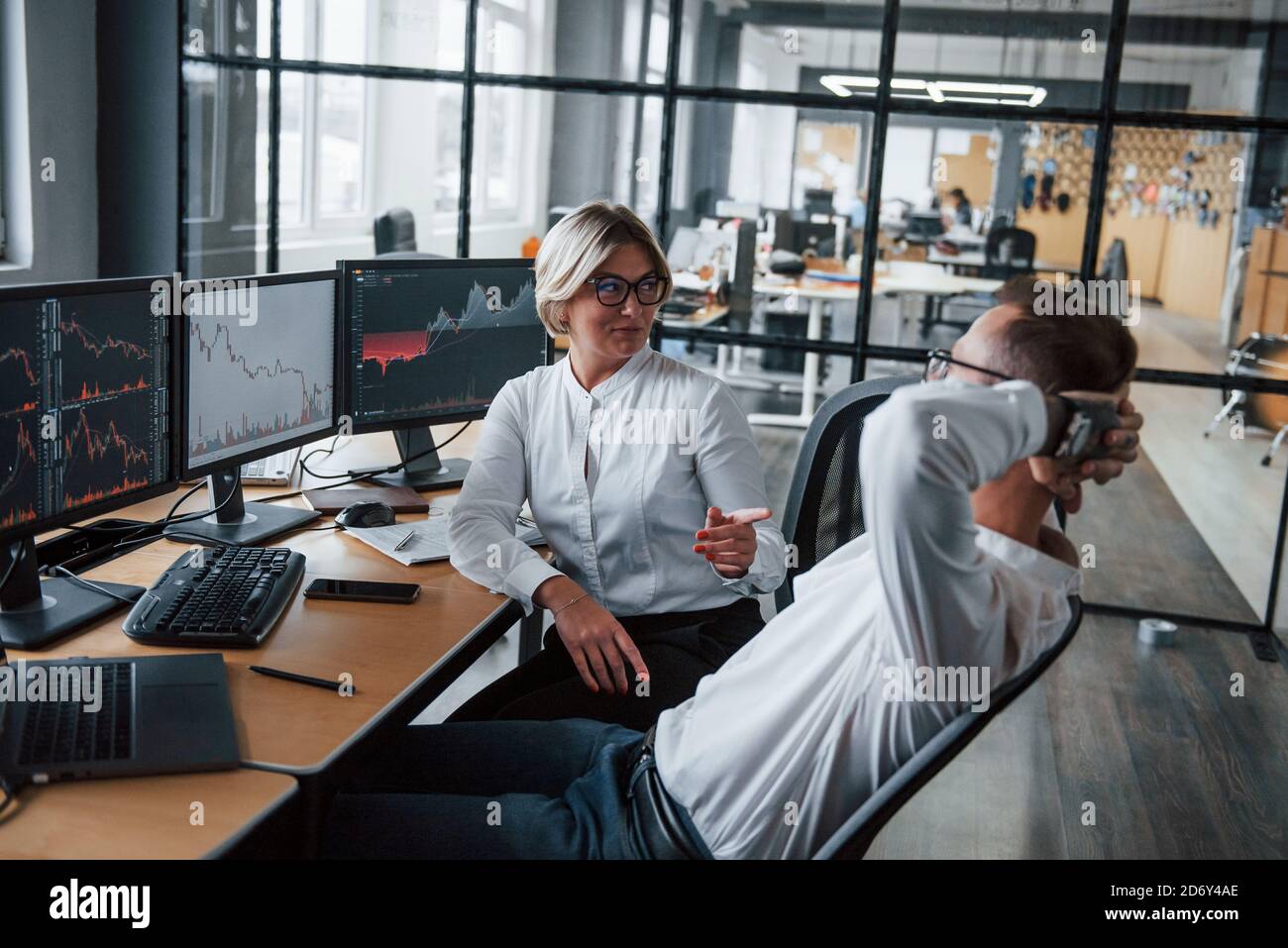 Talking to each other. Two stockbrokers in formal clothes have a break ...