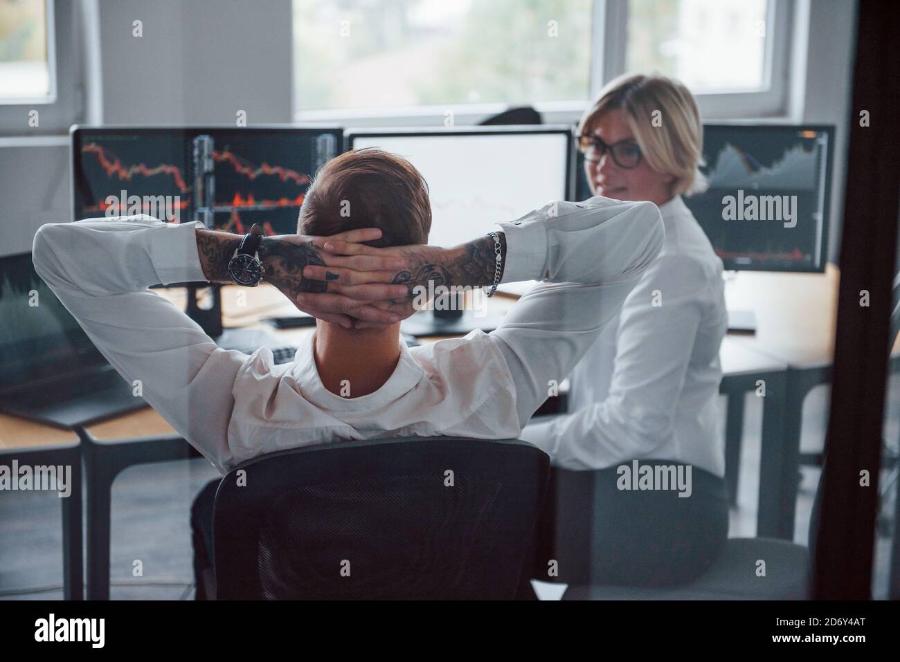 Talking to each other. Two stockbrokers in formal clothes have a break ...