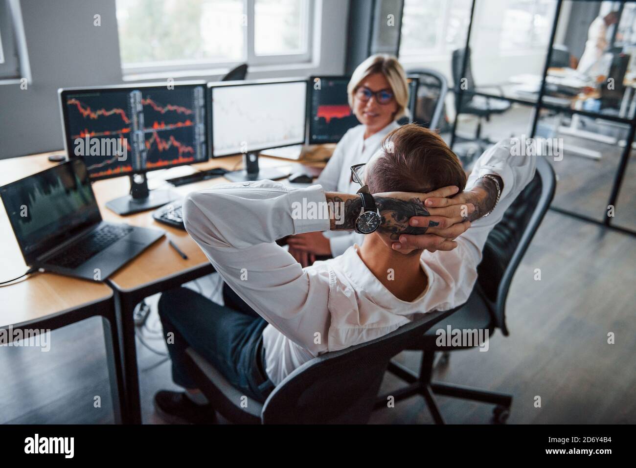 Talking to each other. Two stockbrokers in formal clothes have a break ...