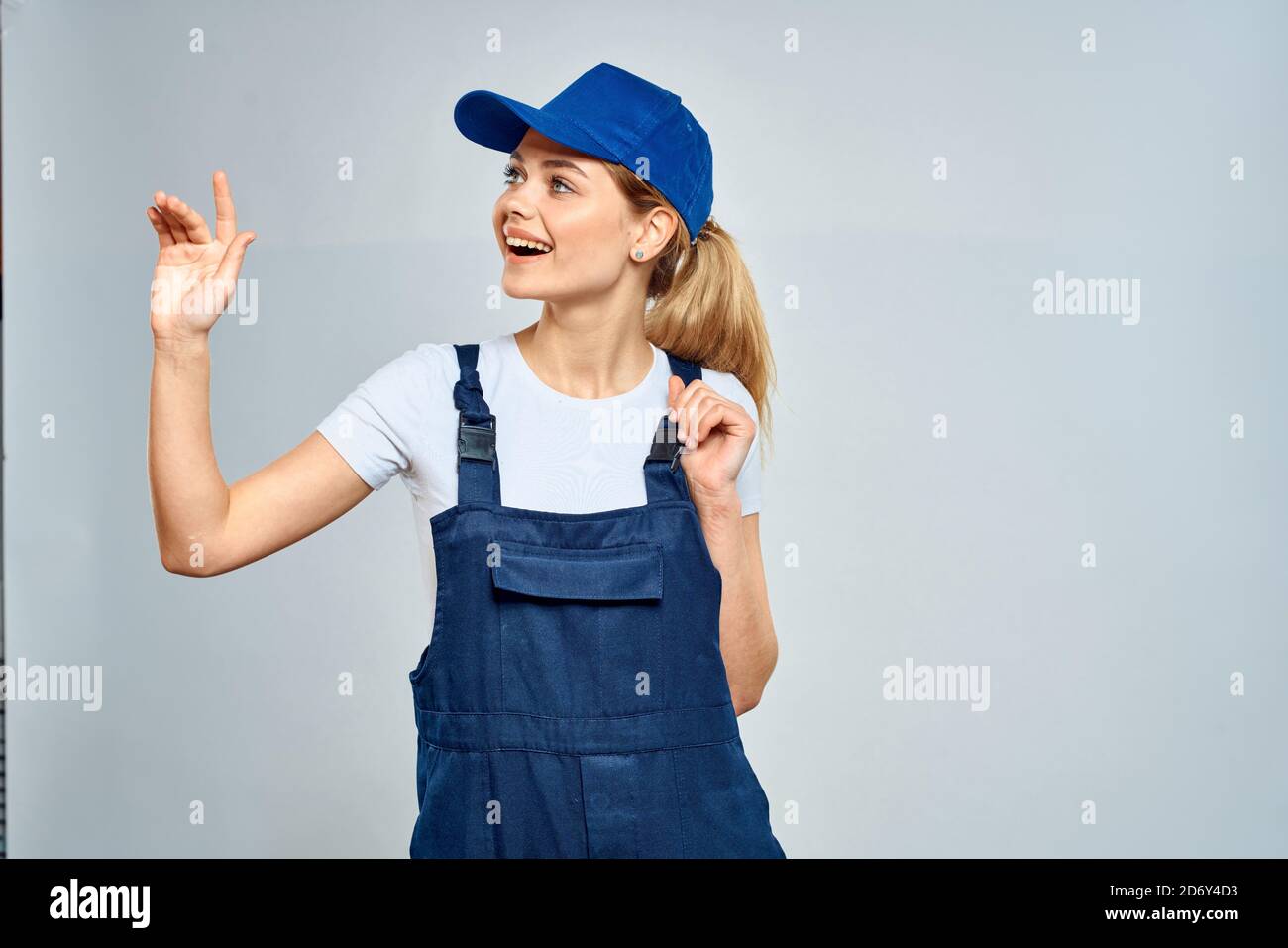 woman in work uniform blue cap service delivery service light ...