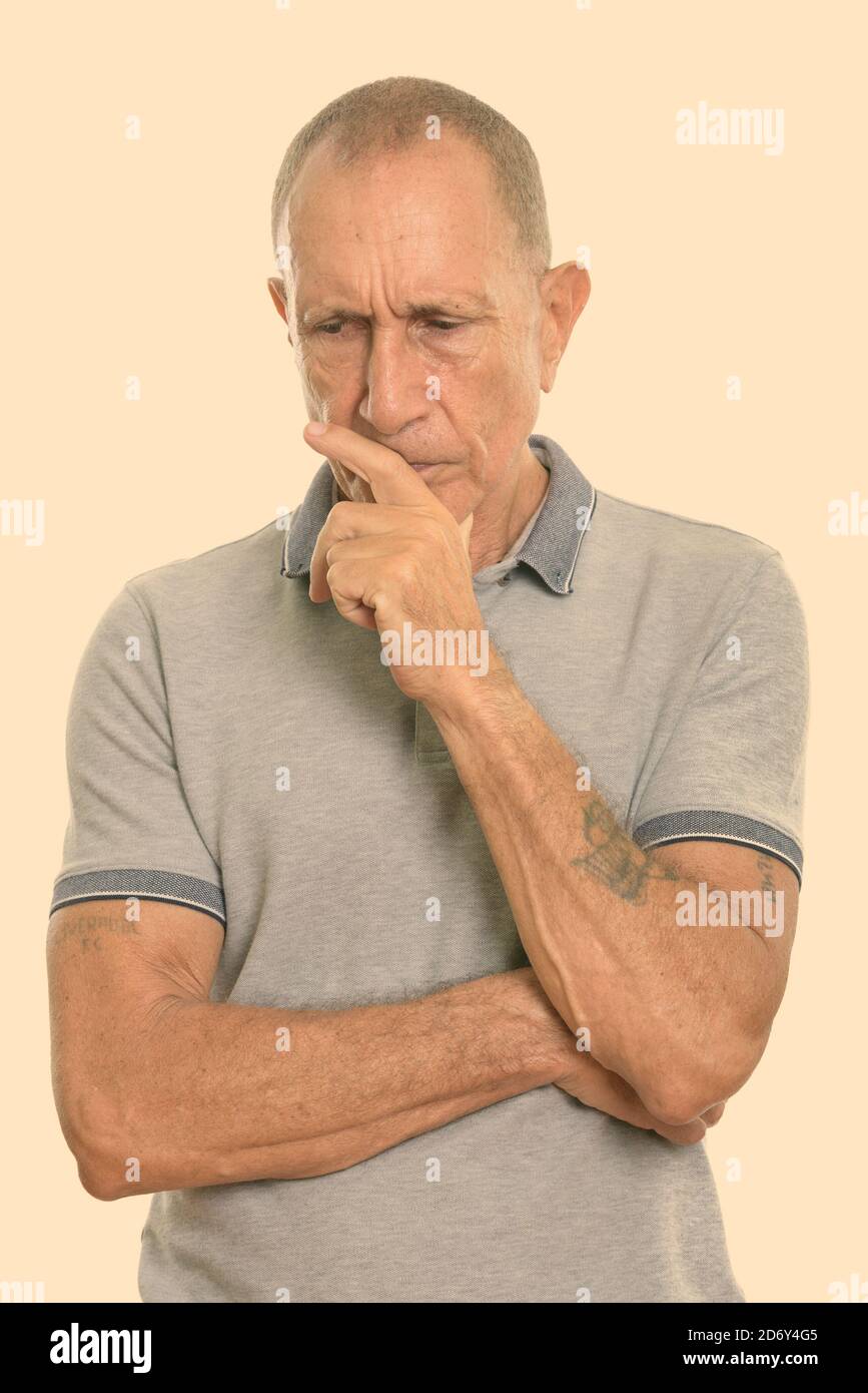 Studio shot of senior man thinking Stock Photo - Alamy