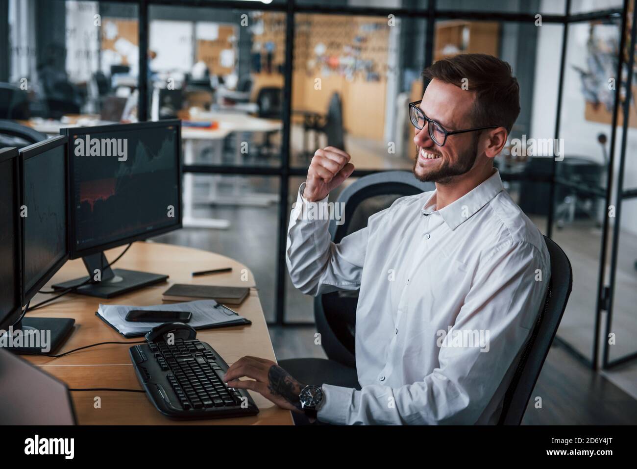 This is success. Male stockbroker in formal clothes works in the office ...