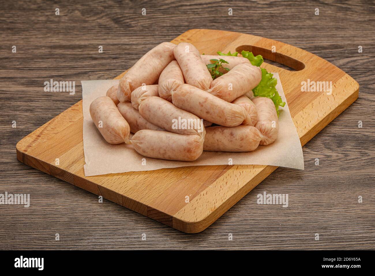 Raw natural chicken baby sausages for roast Stock Photo - Alamy