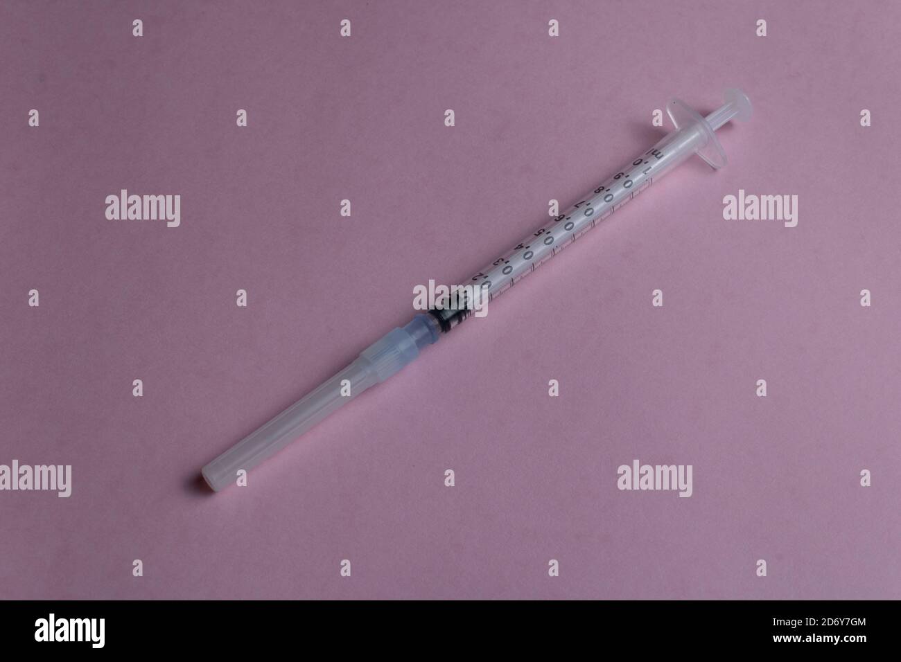 syringe with isolated needle on a clean pink background Stock Photo - Alamy