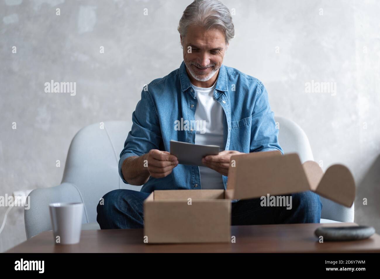 Smiling man consumer open cardboard box get postal parcel, male ...