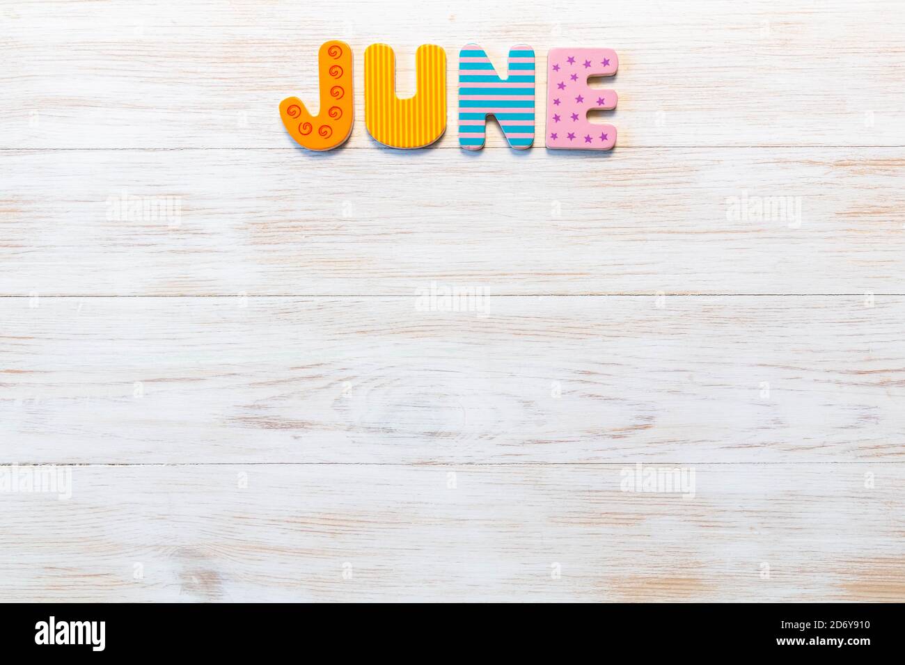 Wooden letters written June month on vintage background. Inscription ...