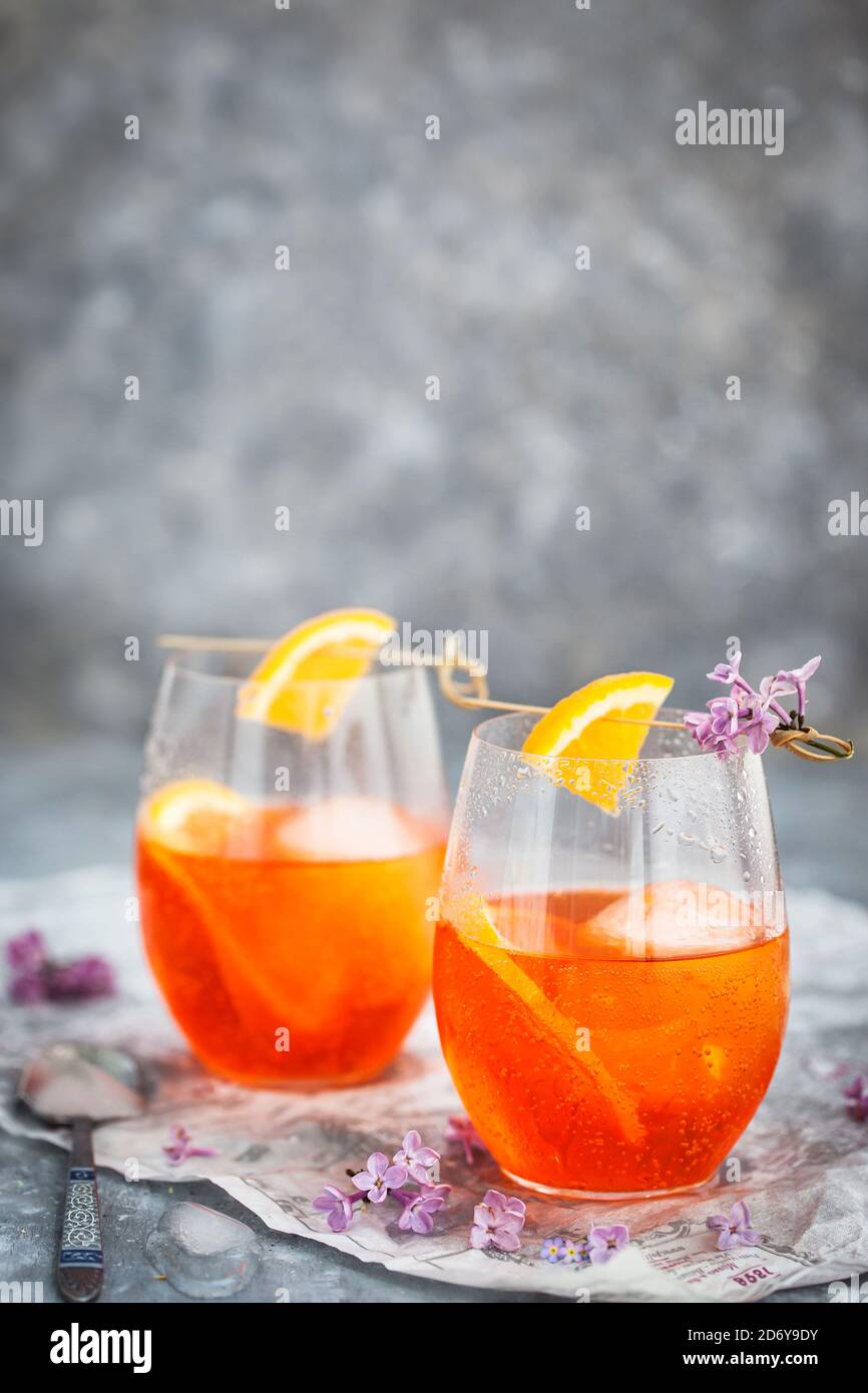 Orange Aperol Spritz cocktail served in a wine glasses, decorated with ...