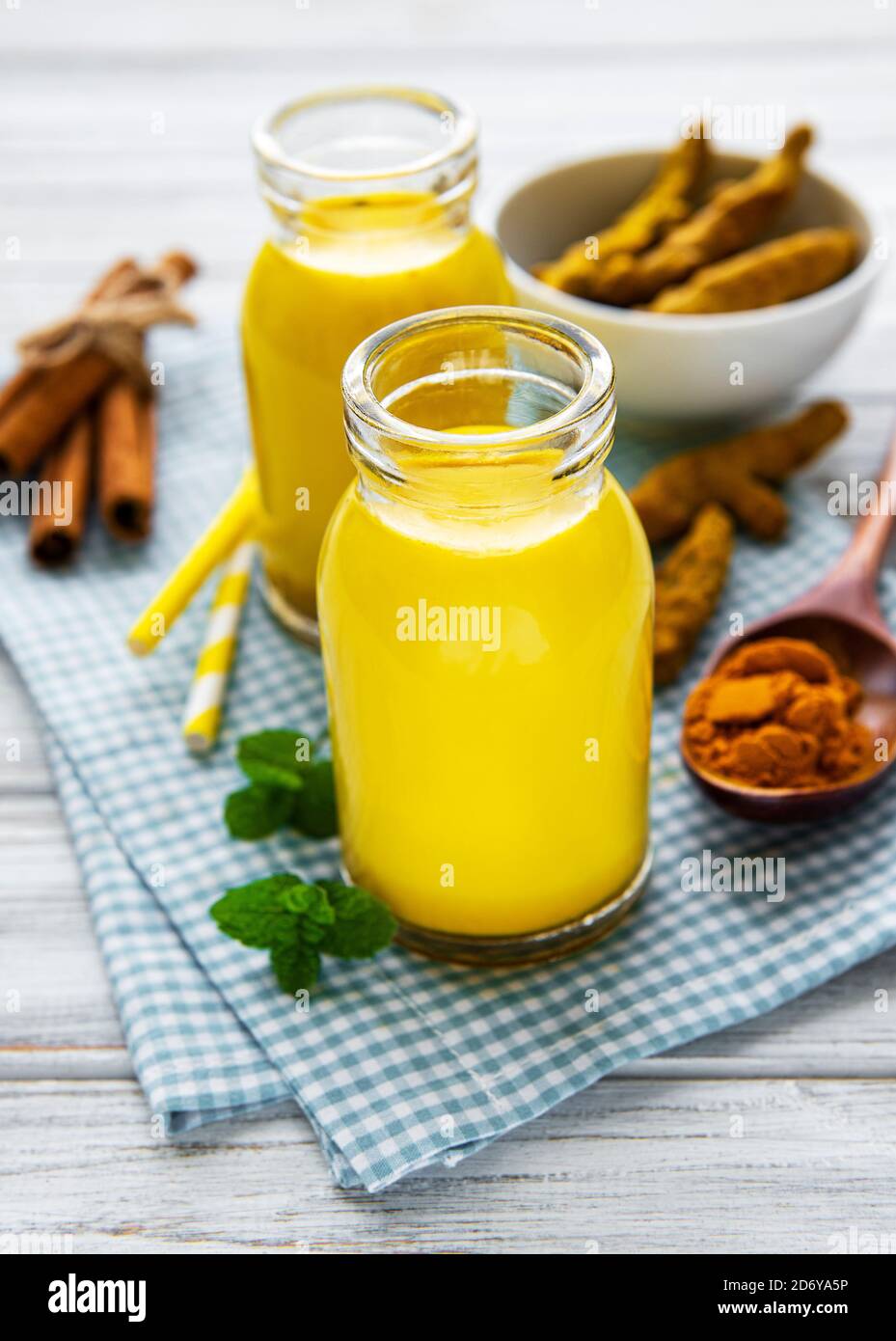 Yellow turmeric latte drink. Golden milk with cinnamon, turmeric ...
