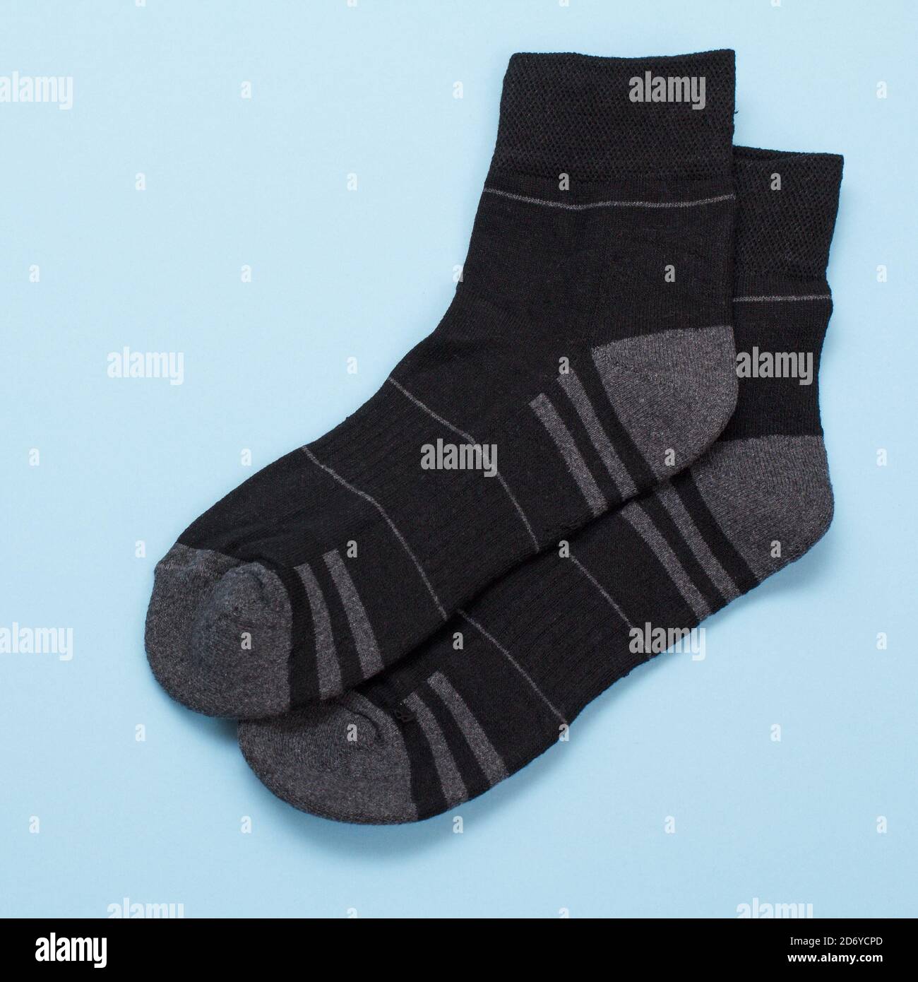 Pair of black warm woolen men socks on a blue background, Top view with ...