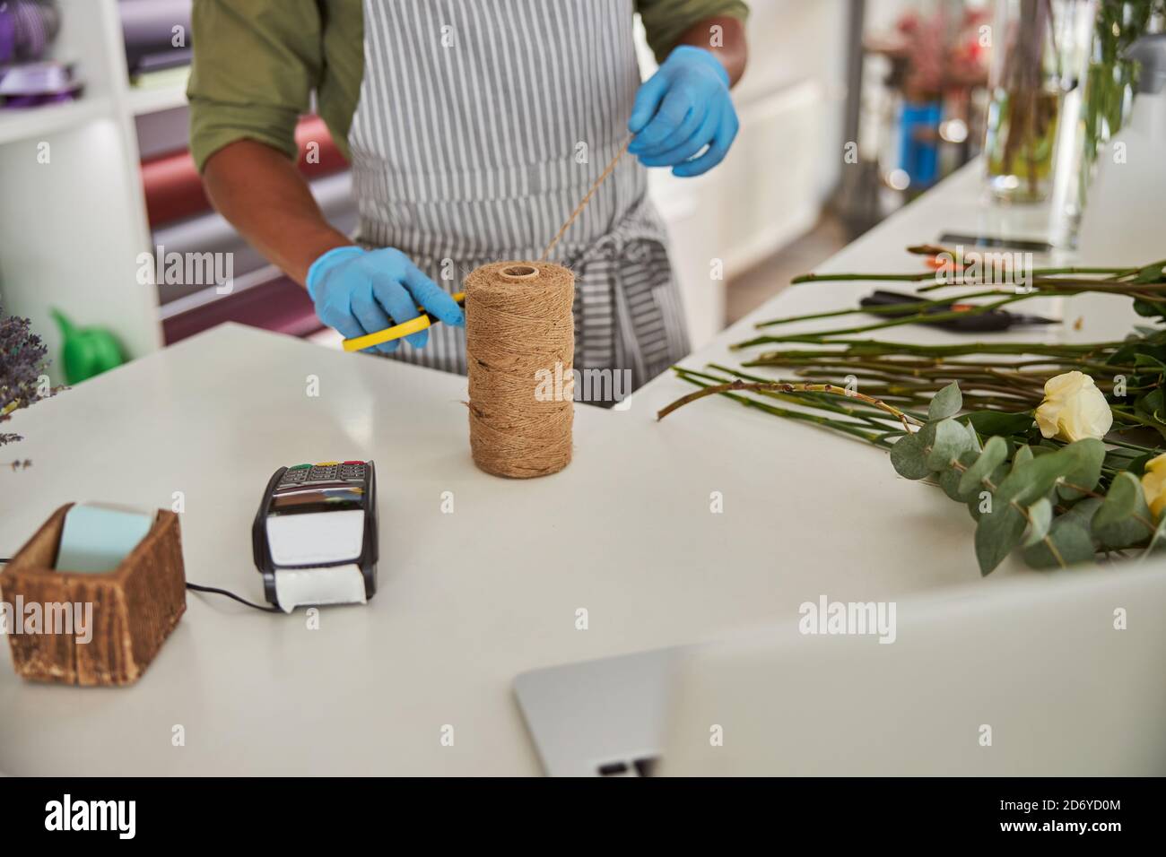 Man selling flowers at counter modern shop Stock Photo - Alamy
