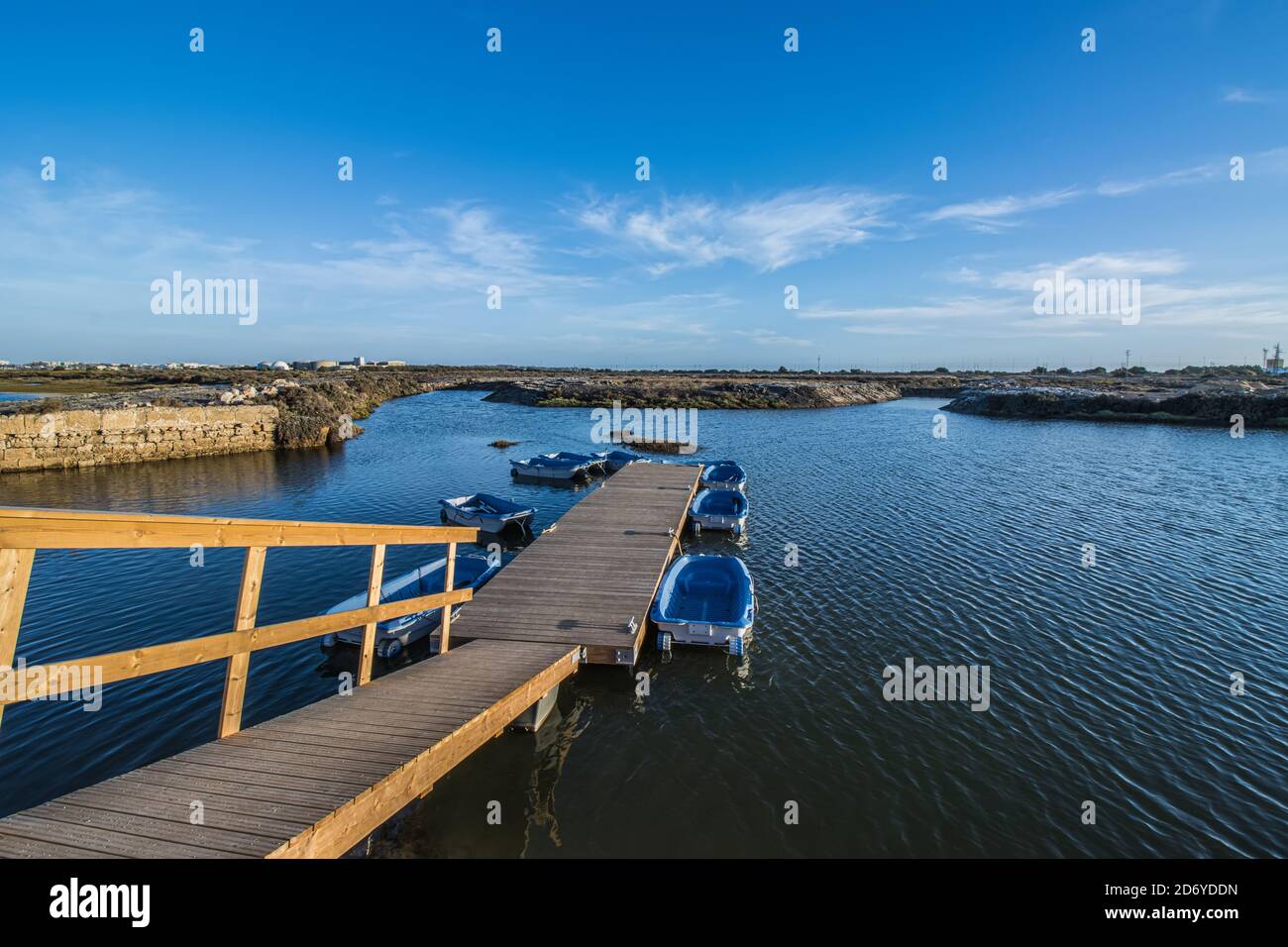boat near the pier on marsh under blue sky day Stock Photo - Alamy