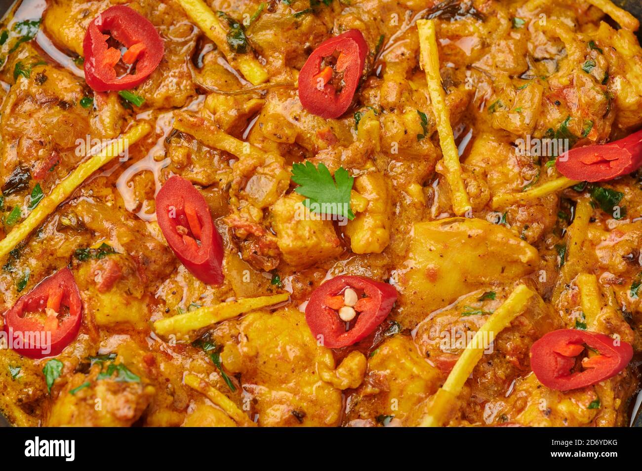 Chicken Handi in black bowl on dark slate table top. Murgh Chicken is ...