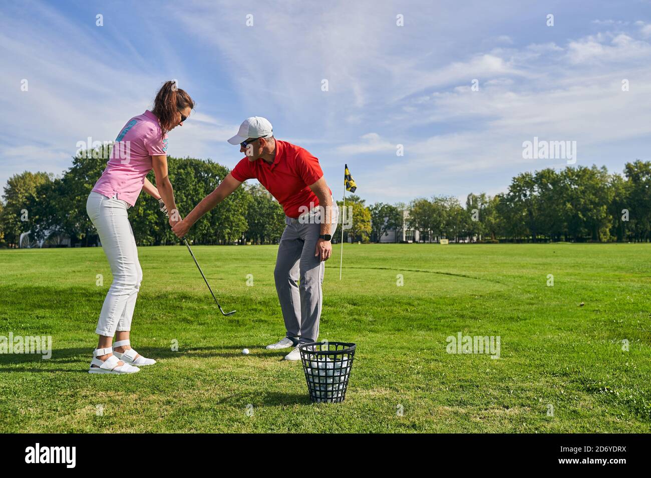 Beginner female golfer learning a proper golf grip Stock Photo - Alamy