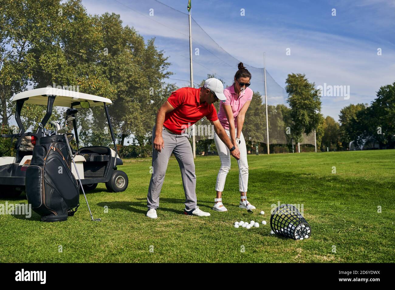 Woman getting ready to strike the ball Stock Photo - Alamy
