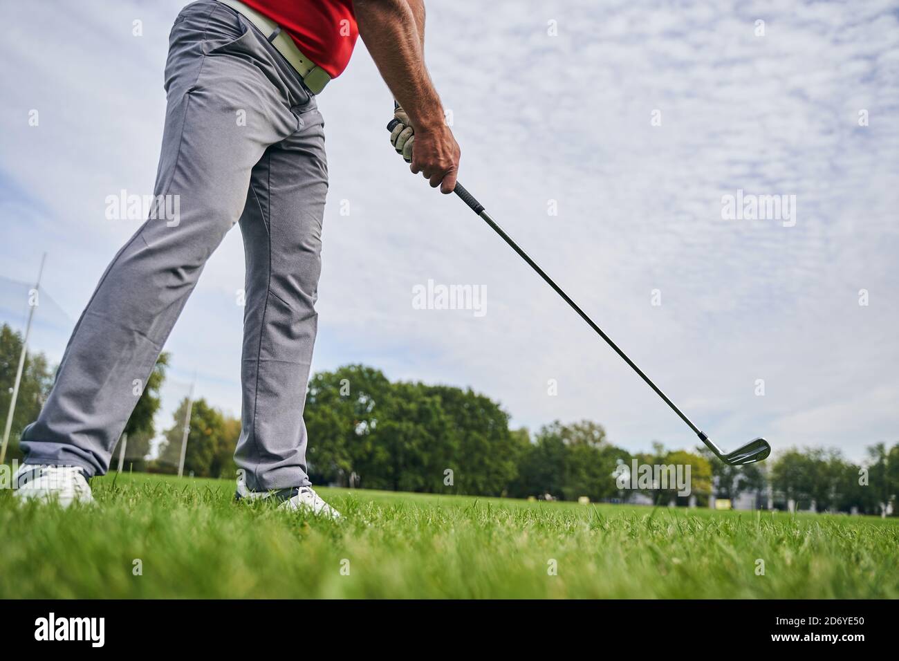 Sportsman with a golf club training outdoors Stock Photo - Alamy