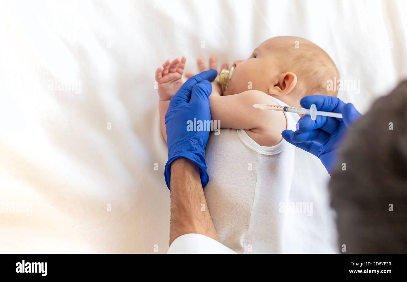 Vaccination baby, injection in the arm. Selective focus. People Stock ...